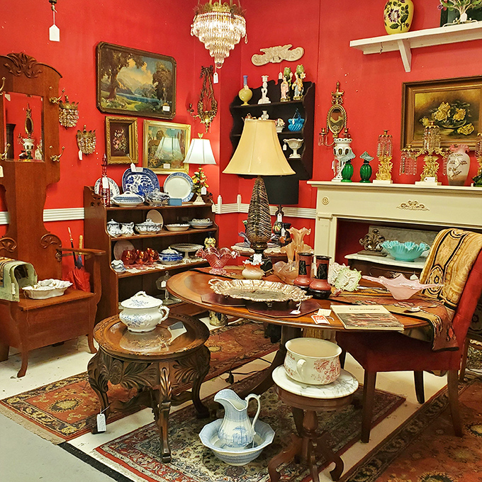 Crimson walls create the perfect backdrop for this elegant display of vintage china and crystal. Downton Abbey meets Nashville chic!