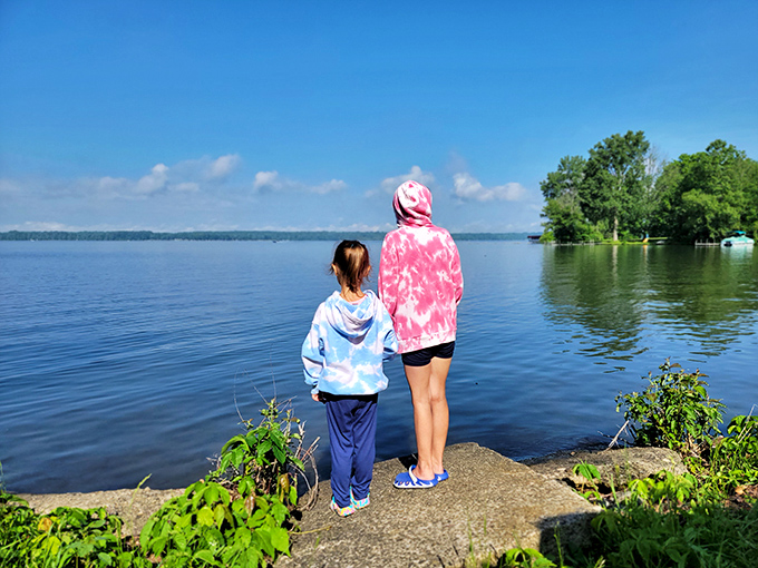Moments like these shape childhoods. Two visitors taking in the vastness of Pymatuning Lake, creating memories that will outlast any video game achievement.