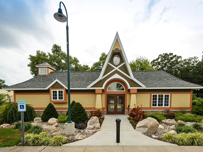 The distinctive Visitors Cottage welcomes garden explorers with its whimsical peaked roof&mdash;architectural proof that even buildings can wear fancy hats. 