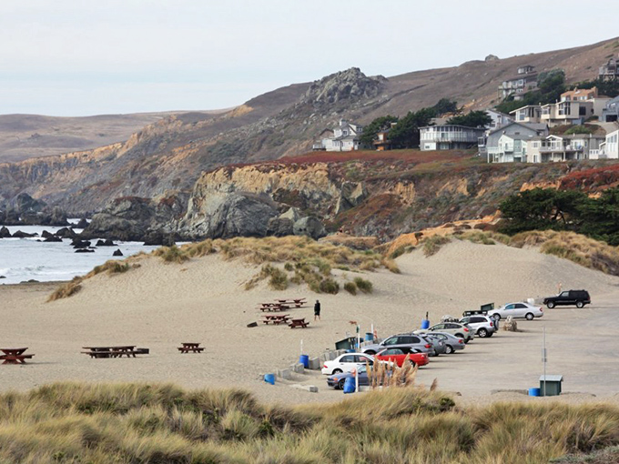 Coastal homes perch like curious seabirds on the bluffs, watching over a beach where parking, picnics, and peace coexist in rare harmony.