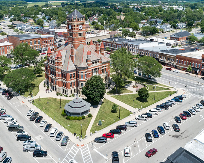 The Williams County Courthouse stands like a red brick castle, its clock tower surveying the town it's anchored for generations.