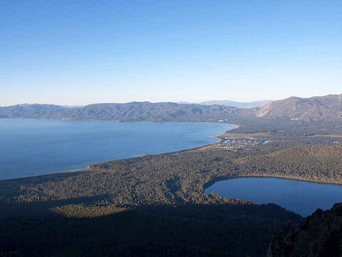 Mother Nature showing off again! This aerial view captures Lake Tahoe's impossible blue nestled among pine-covered mountains like a sapphire on nature's display shelf.