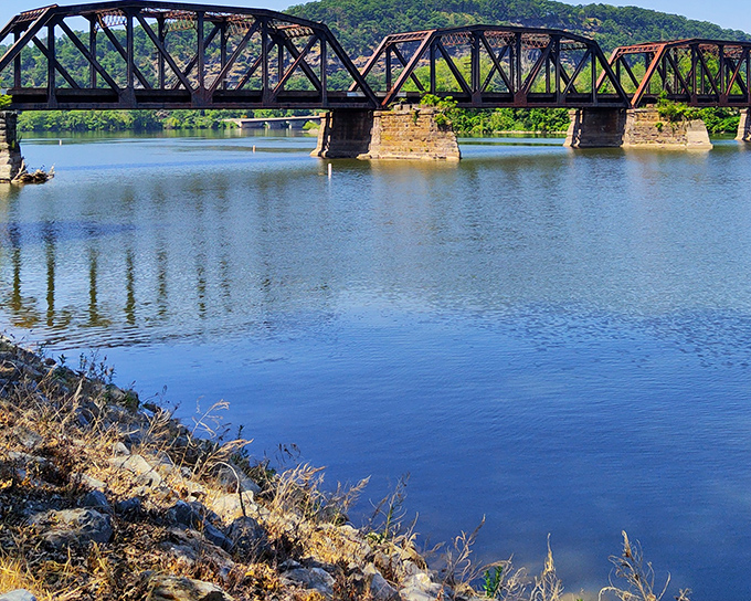 This isn't just any bridge &ndash; it's a time machine spanning both river and decades, its weathered steel trusses telling stories of countless crossings.