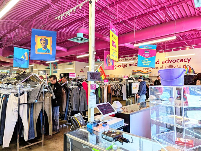 Colorful banners featuring iconic figures hang overhead while shoppers browse. The vibrant atmosphere makes bargain-hunting feel like a joyful celebration rather than a necessity.