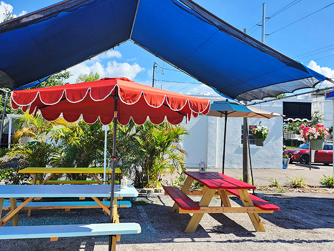 Simplicity at its finest: colorful picnic tables under blue canopies create the perfect no-frills setting for serious seafood enjoyment.