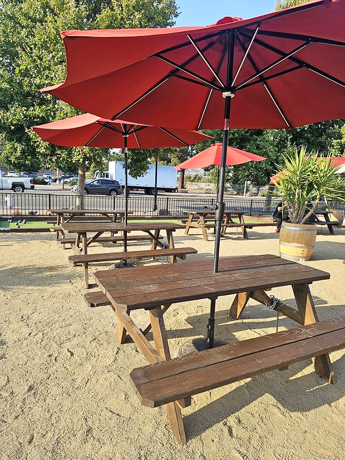 Sunshine, shade, and the promise of culinary bliss. These picnic tables have witnessed countless food epiphanies under cheerful red umbrellas.