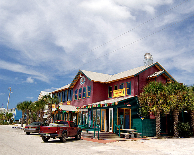 The iconic Red Bar stands as Grayton's beating heart, where locals and visitors alike gather for cold drinks, live music, and the town's unofficial motto: "Nice Dogs, Strange People."