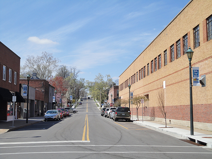 Downtown Cape's gentle slope leads the eye upward, brick buildings standing like sentinels of history against a brilliant blue Missouri sky.
