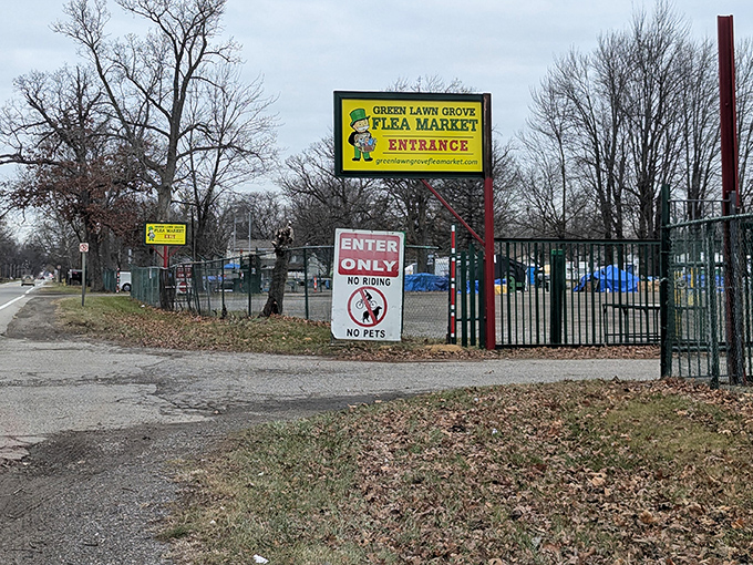 Not just an entrance&mdash;a portal to possibility. The bright yellow sign promises adventures in bargain archaeology just beyond the gate.