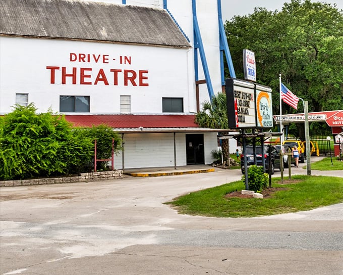 The iconic white facade with bold red lettering announces you've arrived somewhere special, a portal to simpler times when entertainment didn't require a password.