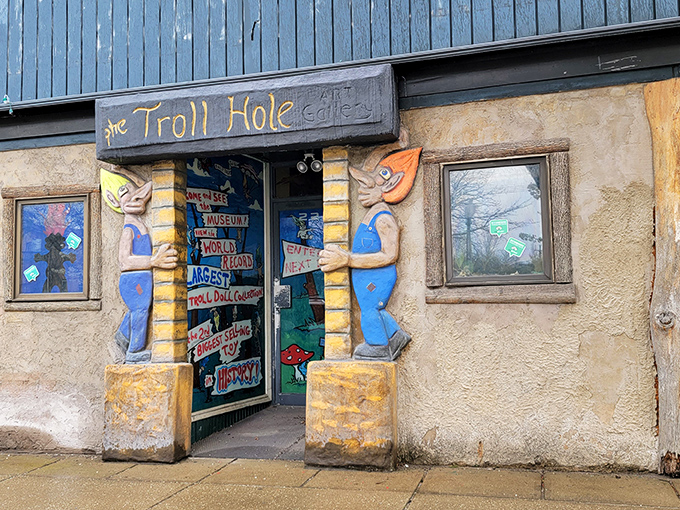 Guarded by blue troll sentinels, this whimsical entrance promises the beginning of an adventure that's equal parts charming and delightfully strange.