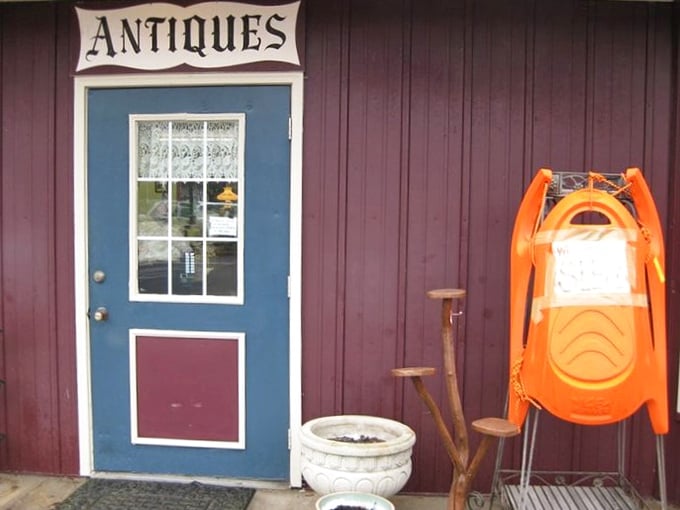 That blue door isn't just an entrance&mdash;it's a portal to the past, complete with an orange sled standing guard like a sentinel of winters gone by.