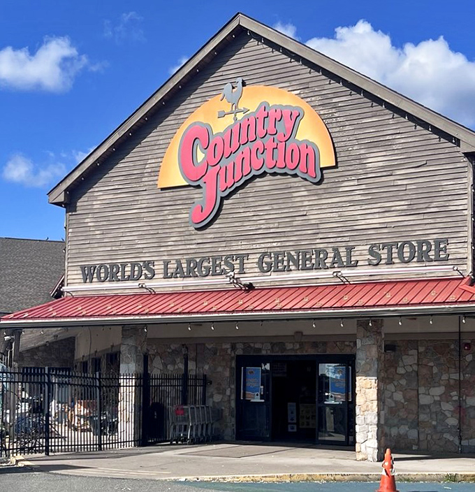 Blue skies frame the iconic Country Junction sign, where the weathervane rooster has been pointing shoppers toward retail bliss for generations.