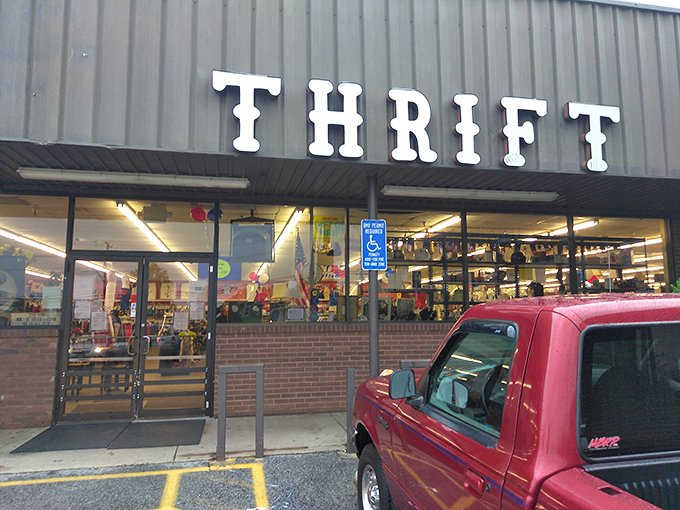 Bright "THRIFT" letters beckon bargain hunters like a lighthouse for the budget-conscious. The red truck seems to know the secret already.