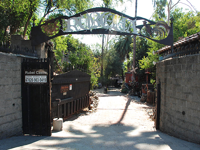 "Abandon ordinary, all ye who enter here." The wrought-iron archway welcomes visitors into a world where imagination trumped building codes.