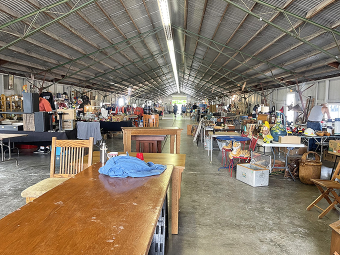 The indoor section feels like a time machine showroom, where wooden tables from five different decades wait patiently for their next chapter to begin.