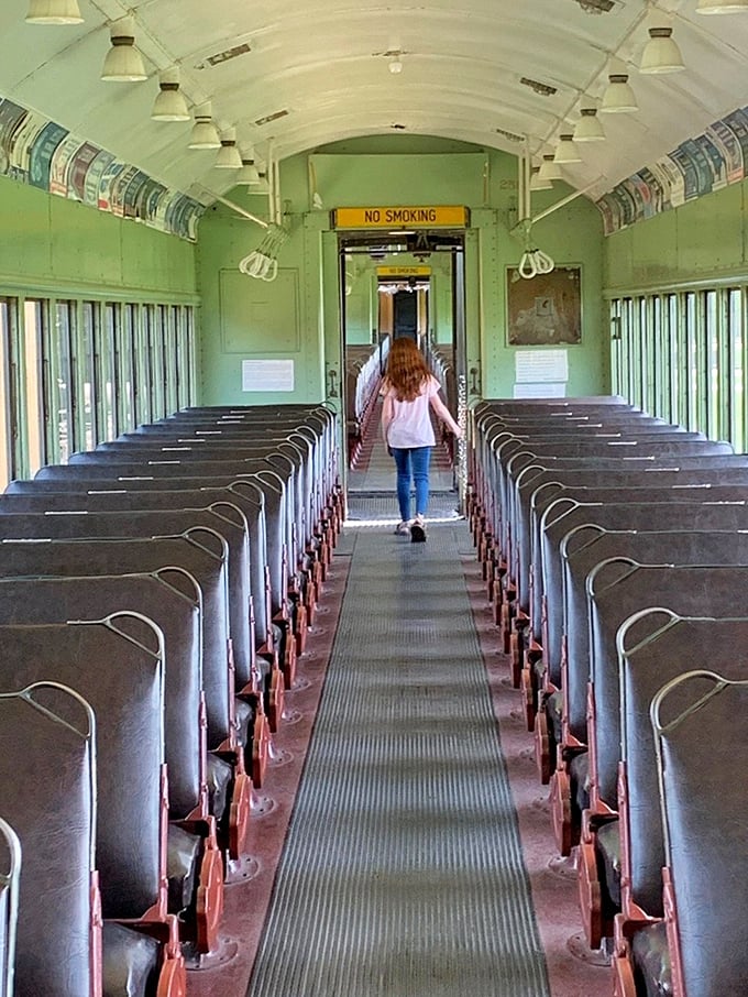 Step inside a vintage passenger car where the mint-green interior and "No Smoking" sign transport you to an era when train travel was an elegant affair.
