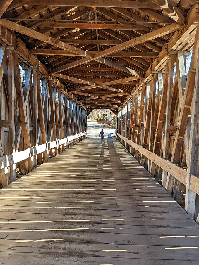 Sunlight plays hide-and-seek through the intricate wooden lattice ceiling, creating ever-changing patterns on the worn planks below.