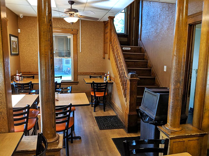 Step inside and discover a cozy interior where wooden columns and staircase create the feeling of dining in someone's beloved family home rather than just another fast food joint.