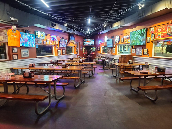 Picnic tables and memorabilia-lined walls create that rare atmosphere where both college freshmen and grandparents feel equally at home.