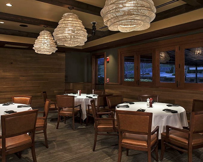 Warm wood and elegant lighting create the perfect atmosphere where comfort meets sophistication in dining harmony.