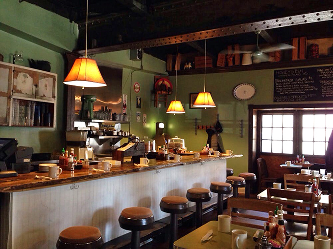 Mint green walls, amber pendant lights, and worn wooden stools create the perfect backdrop for breakfast epiphanies. Comfort incarnate.