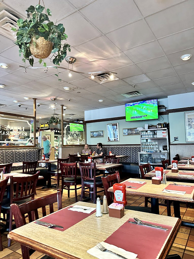 Classic diner charm meets cozy comfort inside Little Pete's. Hanging plants, wooden tables, and TVs showing the game create that "everybody knows your name" vibe.