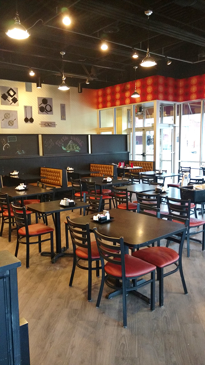 Modern comfort defines Wally Waffle's interior, where caramel-colored booths and kitchen-themed artwork create the perfect backdrop for morning revelations.