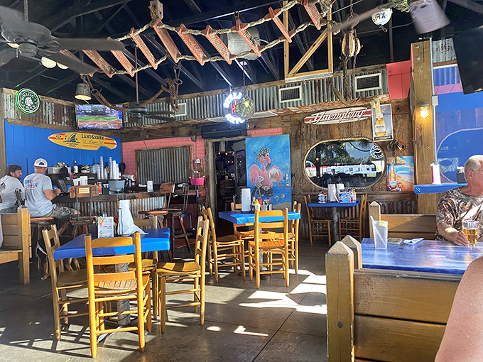 Step inside and you're greeted by rustic wooden beams, nautical touches, and those signature blue tables. It's Florida beach culture distilled into restaurant form.