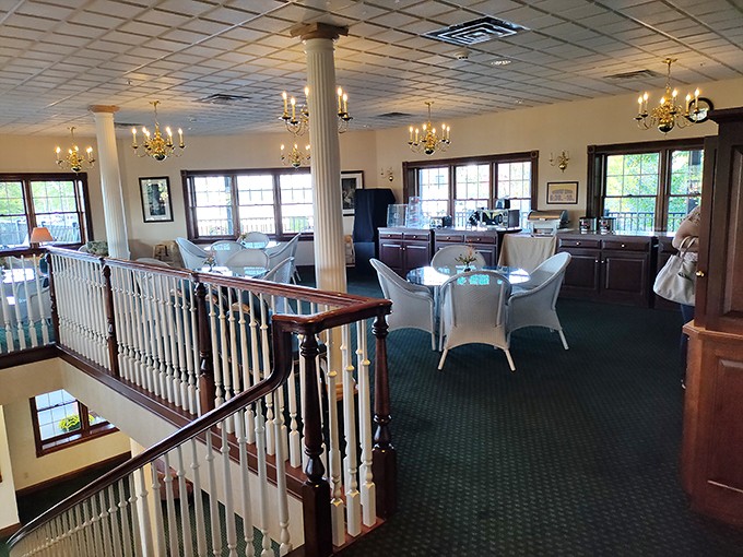 Elegant chandeliers illuminate the multi-level dining area, where polished wood railings and comfortable seating invite you to settle in for the long haul.