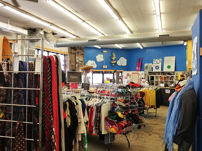 Racks upon racks of possibility! The interior reveals clothing organized by type, with those whimsical cloud decorations adding unexpected charm to the industrial ceiling.