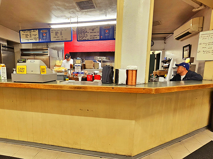 Behind this no-nonsense counter, breakfast dreams come true. The "Cash Only" sign isn't a deterrent&mdash;it's a badge of old-school authenticity.