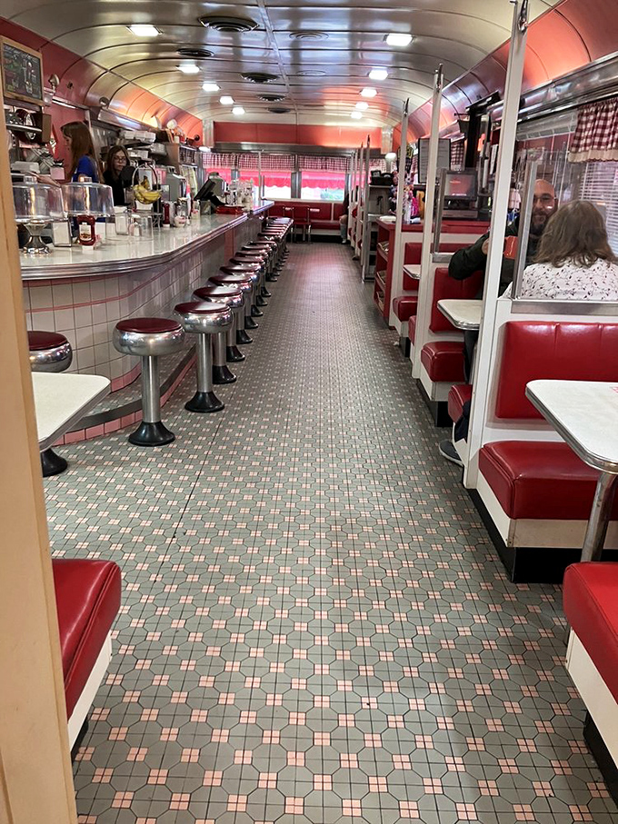 Step inside this classic diner car and time melts away. The gleaming counter, red vinyl booths, and patterned floor create a Norman Rockwell painting come to life.