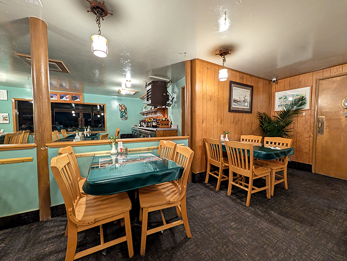 Cozy wood-paneled interior where seafood dreams come true. Turquoise walls and warm lighting create the perfect backdrop for maritime feasting.