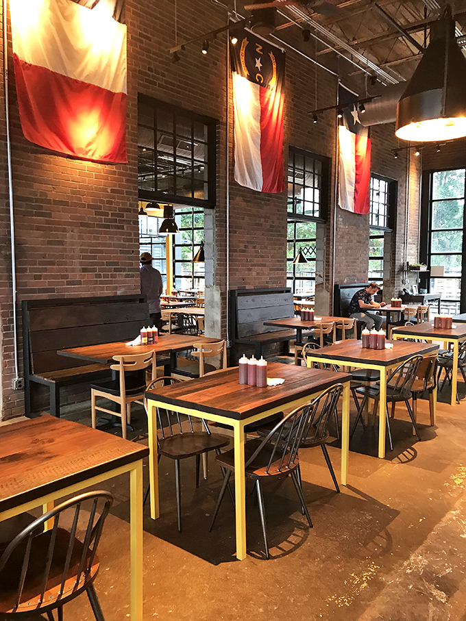 State flags hang like culinary battle standards above wooden tables where serious eating happens. The high ceilings ensure your "mmms" have room to echo.