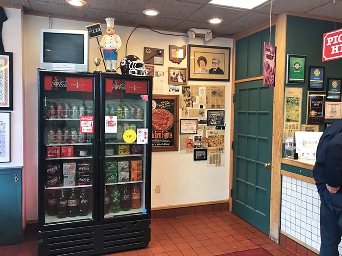 Vintage memorabilia and a classic Coca-Cola cooler &ndash; this isn't just decoration, it's a time machine to when pizza joints had soul.