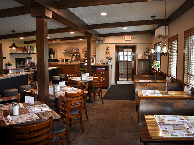 Wooden beams, warm lighting, and tables set for comfort rather than Instagram. This is where memories are made between bites of perfect pancakes.