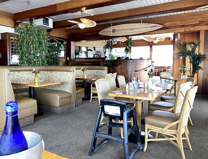 Inside, surfboards hang from wooden-beamed ceilings while rattan chairs invite you to settle in. Vacation mode: activated.