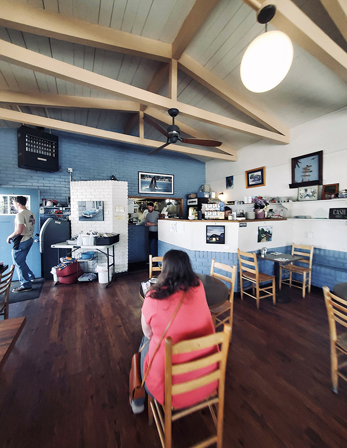 High ceilings, blue walls, and wooden beams create that perfect "come as you are" vibe. The kind of place where calories don't count and coffee refills are practically mandatory.