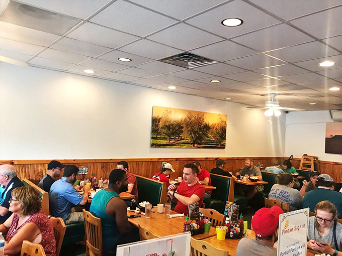Inside, wooden wainscoting and landscape art create that perfect diner atmosphere where strangers become regulars and regulars become family over countless coffee refills.
