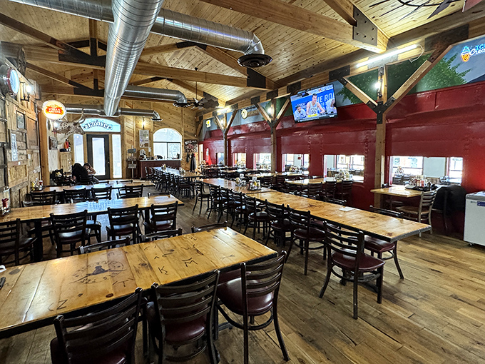 Rustic elegance meets cowboy comfort in this wood-beamed dining room. The red walls and weathered tables create the perfect backdrop for serious barbecue contemplation.