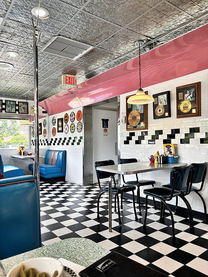 Step into a time machine where checkered floors meet blue vinyl booths. The gold records on the wall aren't just decoration&mdash;they're conversation starters.