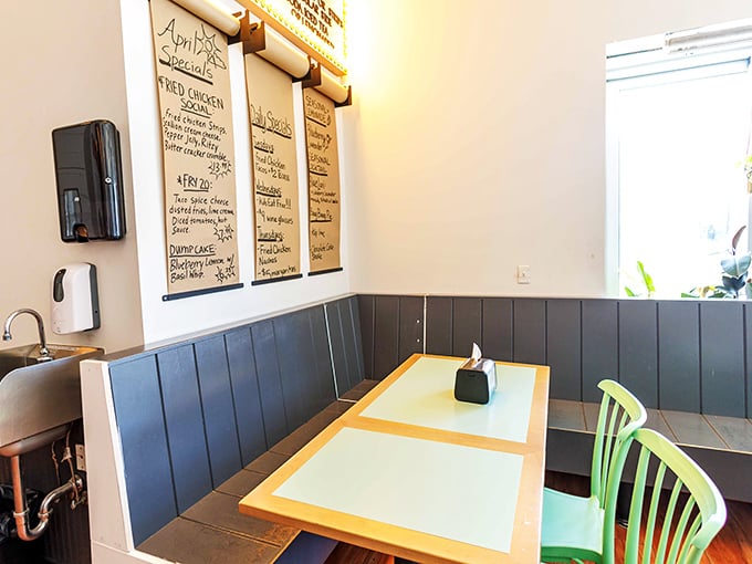 Simple blue wainscoting and bright green chairs create that perfect "come as you are" vibe where both hipsters and grandparents feel equally at home.
