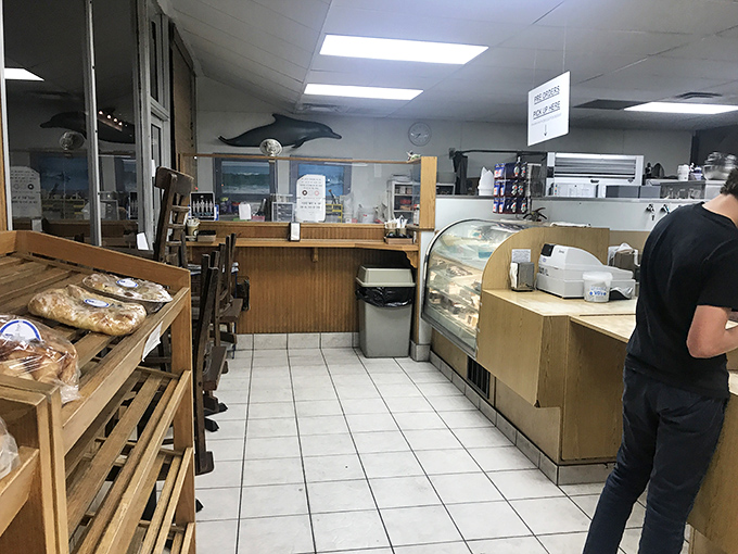 No-frills interior with wooden shelves and simple display cases &ndash; because when your donuts are this good, you don't need fancy d&eacute;cor to impress.