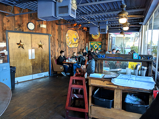 Wooden walls adorned with eclectic art create that perfect "discovered gem" atmosphere where conversations flow as freely as the coffee.