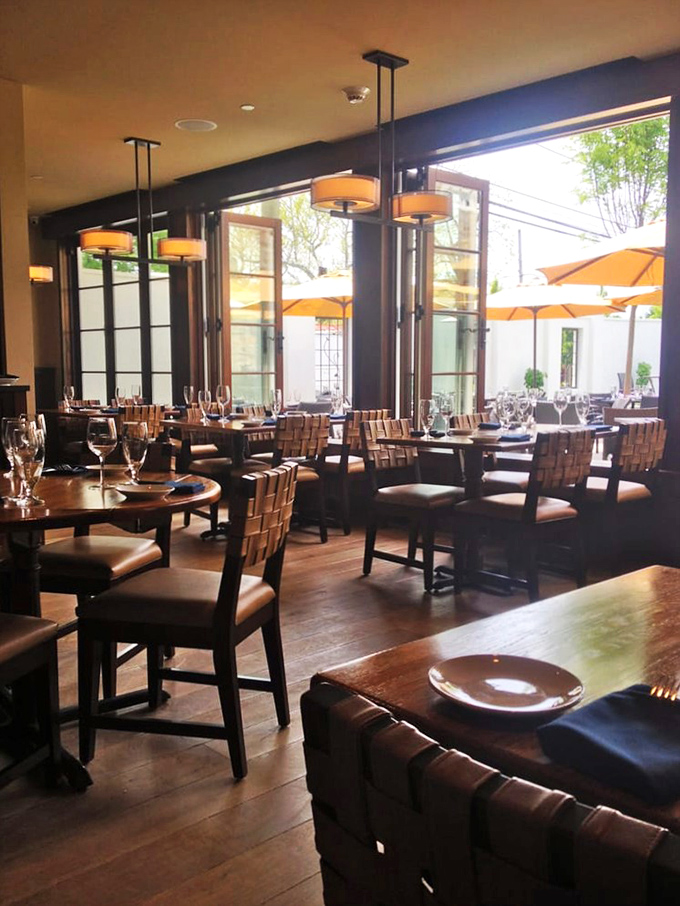 Warm wood tones and leather seating create an atmosphere that's both elegant and inviting. Like a sophisticated friend's dining room, but with better lighting.