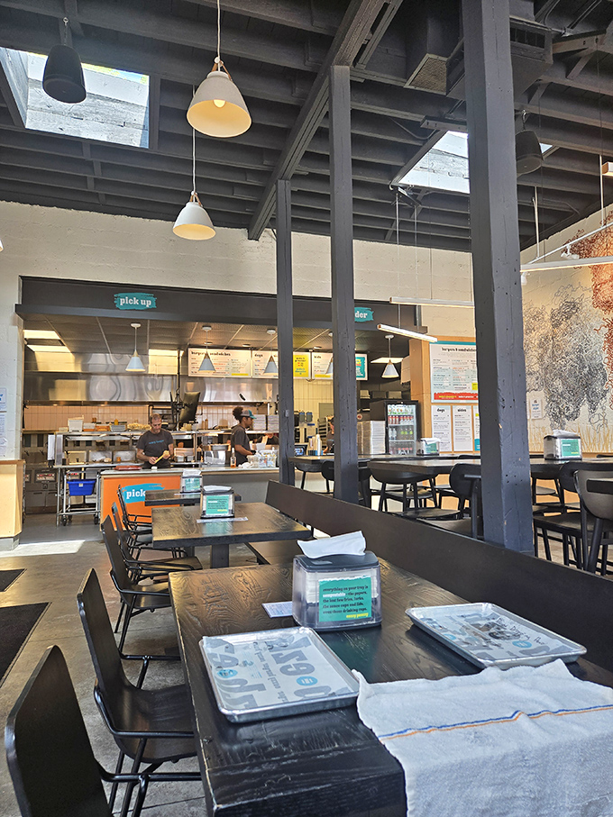 Industrial-chic meets burger paradise inside, where exposed beams and pendant lights create the perfect atmosphere for serious eating.