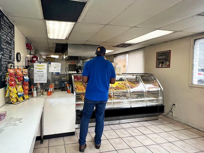 A customer contemplates life's sweetest decisions at the no-frills counter, where Maryland's breakfast dreams have come true for generations.