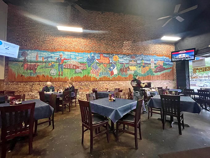 Exposed brick walls and a colorful Texas mural create the perfect backdrop for the culinary magic that happens daily at this Denton institution.