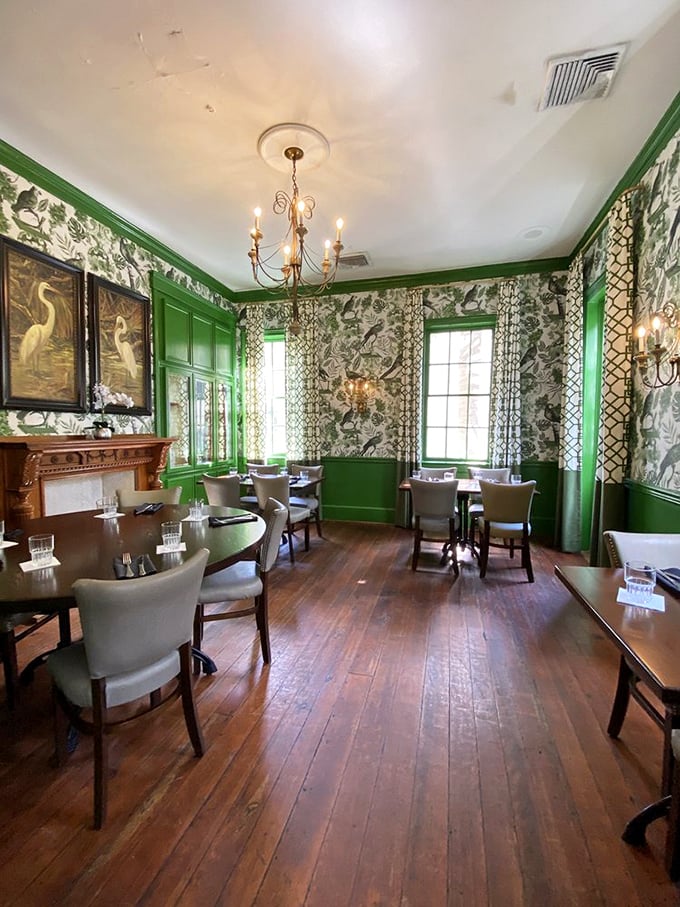 Vibrant green walls and botanical prints create a dining room that's equal parts colonial charm and Southern sophistication. Like dining in your fanciest relative's parlor.